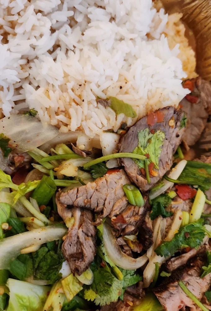 This northeastern Thai salad combines tender beef with herbs, lime, and toasted rice powder, a flavor bomb disguised as a simple dish.