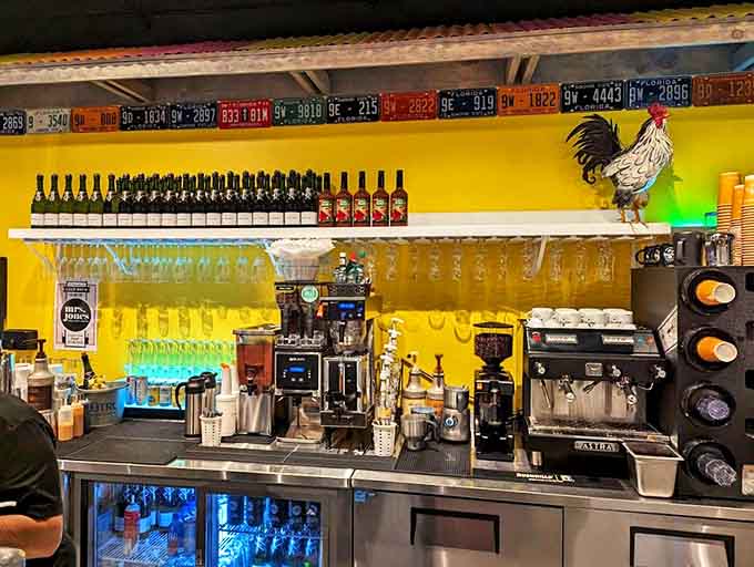 Behind the counter, a collection of license plates and coastal artwork creates a backdrop for baristas crafting coffee drinks that kick-start beach adventures.