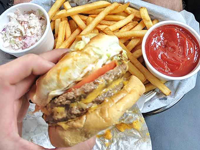 Dashboard dining at its finest: a juicy cheeseburger, crispy fries, and the essential condiments for a mobile feast.