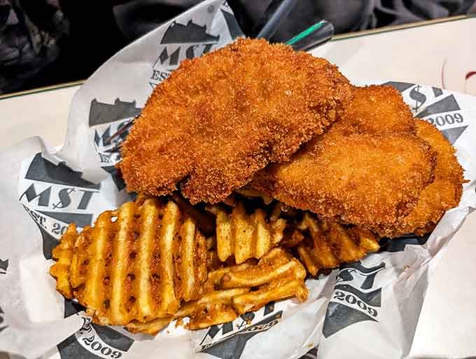 Golden-fried chicken tenders with waffle fries &ndash; comfort food elevated to an art form.