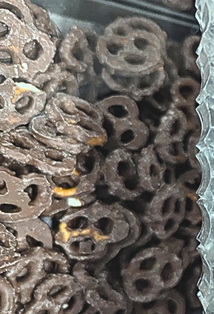 Chocolate-dipped pretzels lined up like edible artwork, each one promising the perfect balance of salt and sweet.