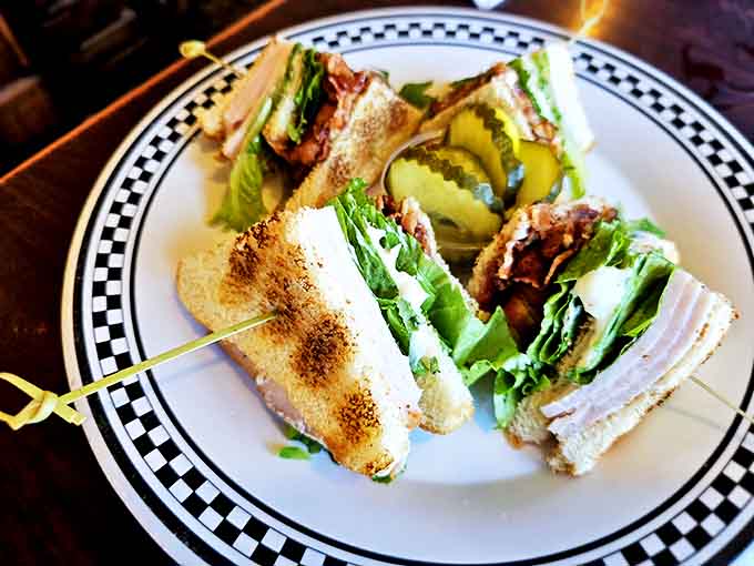 The club sandwich &ndash; a towering testament to the beauty of simple ingredients stacked with architectural precision and served with a pickle spear exclamation point.