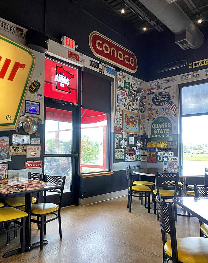 Where vintage gas station signs and road memorabilia create a museum-worthy backdrop for the serious business of enjoying comfort food.