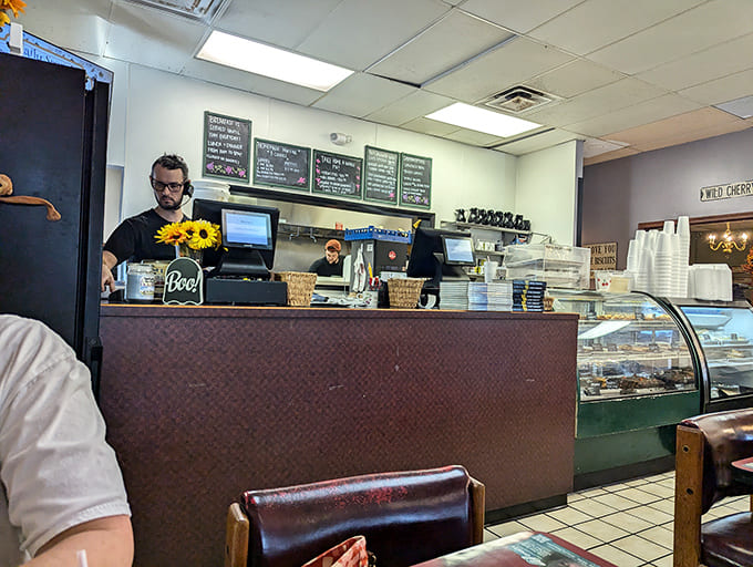 The counter where magic happens – friendly staff, tempting display cases, and the promise of coffee that never reaches empty.