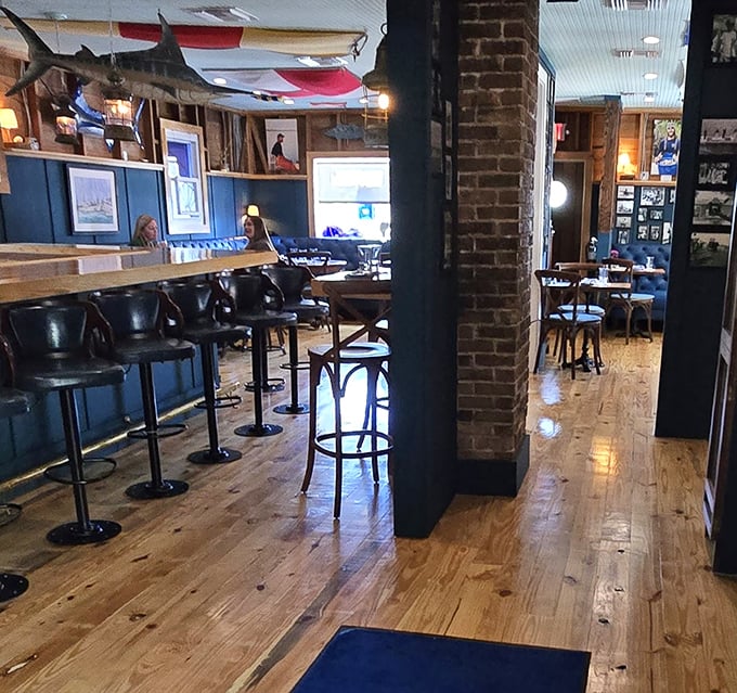 Counter seating offers a front-row view of the action, where polished wood and brick details showcase the restaurant's thoughtful design elements.