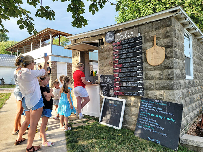 Families line up eagerly at the ordering window, where pizza dreams come true and Wednesday traditions begin.