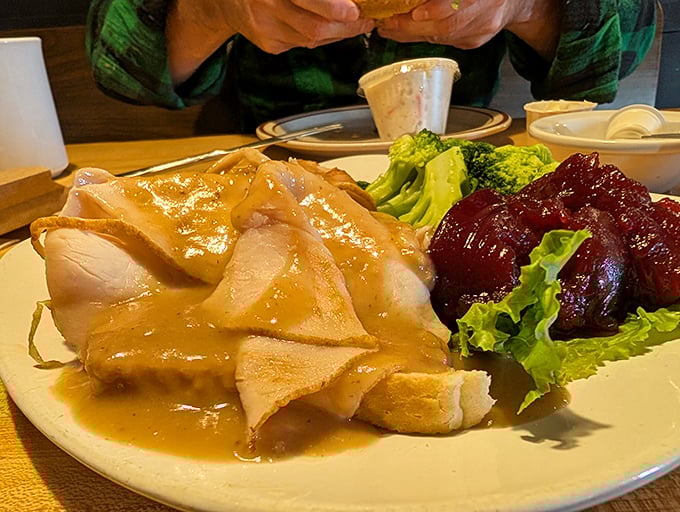 Turkey dinner done right &ndash; tender slices bathed in gravy alongside cranberry sauce and fresh vegetables, a Thanksgiving flashback any day of the year.