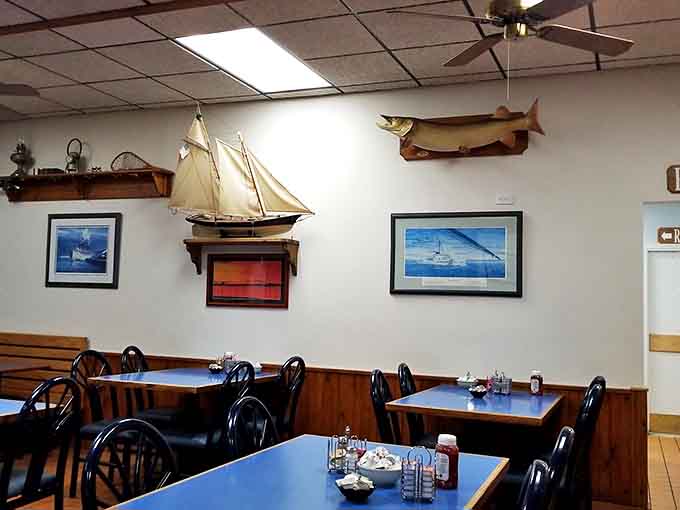 Nautical touches like mounted fish and model sailboats create an atmosphere that celebrates Michigan's Great Lakes maritime heritage.