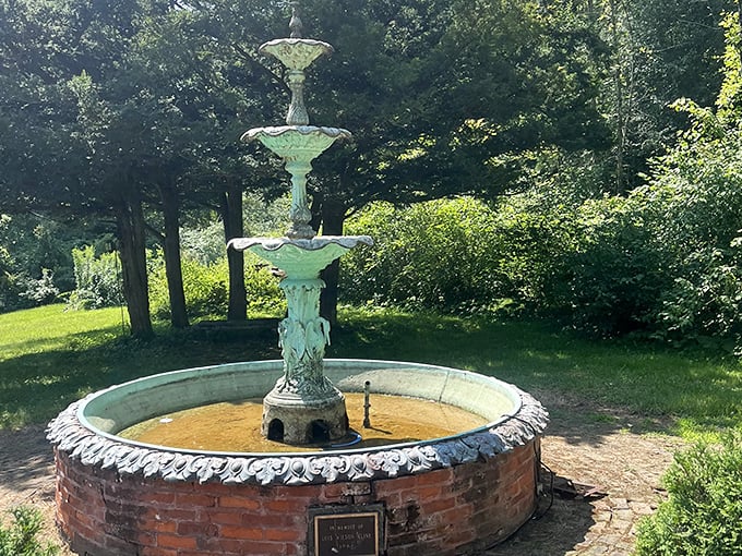 A vintage fountain stands as the centerpiece of formal gardens, its gentle splashing sometimes accompanied by whispers with no visible source.