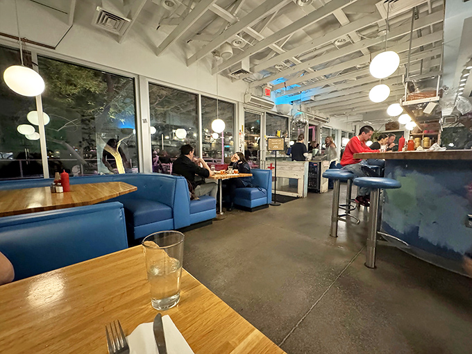 Pendant lights create pools of warmth throughout the space, making every table feel like the best seat in the house.