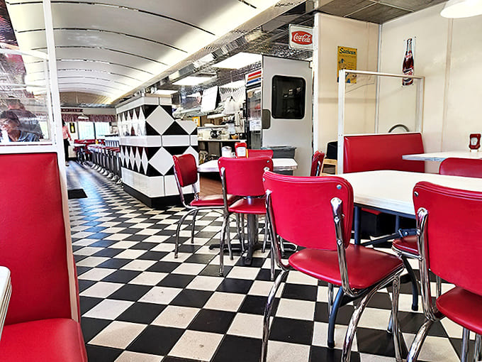 The diner's interior stretches out like a well-designed time capsule, where every detail from the ceiling to the floor tiles speaks of mid-century charm.