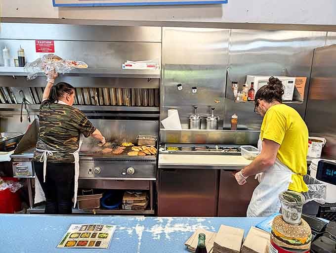 The culinary choreography behind the counter &ndash; where burger artists transform simple ingredients into legendary meals with practiced precision and flair.