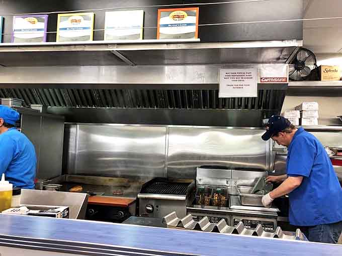 The open kitchen layout means you can watch your brisket being sliced and assembled, which is basically dinner and a show combined.