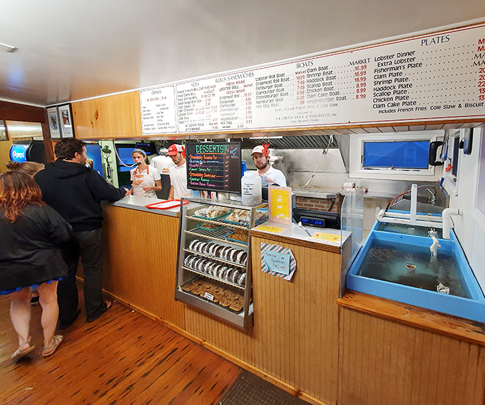 Behind the counter where magic happens – the organized chaos of a kitchen that's been perfecting seafood and pie for generations.