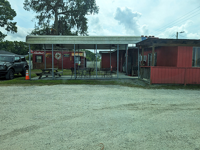 The outdoor patio where smoke-kissed conversations happen under Florida skies. Simple tables, complex flavors&mdash;the perfect barbecue equation.