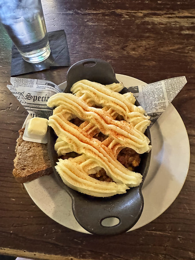 Logan's Mac with Fries transforms comfort food into an art form – corned beef, peas, and scallions nestled in creamy goodness under a golden breadcrumb crown.