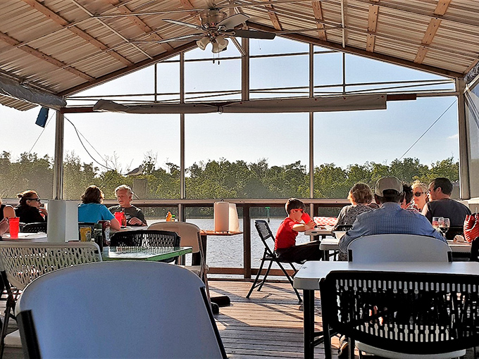 The screened dining area offers protection from mosquitoes while still delivering those million-dollar water views. Best seats in the house.