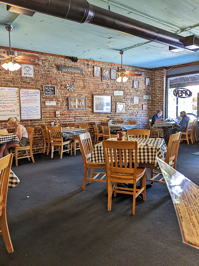 Wooden tables with checkered tablecloths create an atmosphere where conversations flow easily and nobody feels rushed to give up their table.