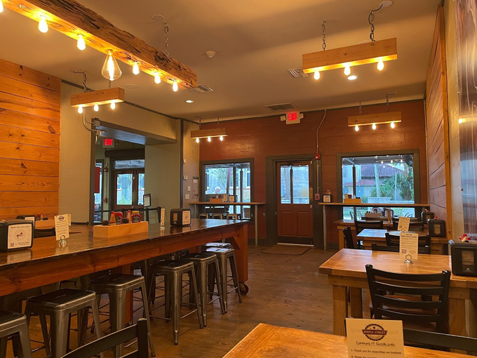 Wooden tables bathed in warm light create a dining space that feels like the cozy breakfast nook you've always wanted in your dream home.