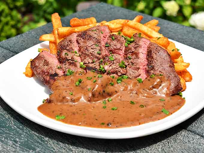 Steak that silences conversation &ndash; perfectly cooked, bathed in peppercorn sauce, with a side of golden fries that somehow remain crispy to the last bite.
