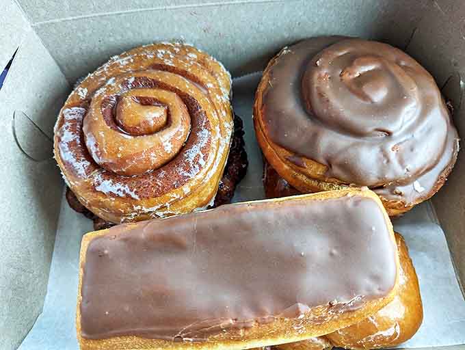 Cinnamon rolls and long johns nestle together in perfect harmony, proving that pastries, unlike people, always get along in close quarters.