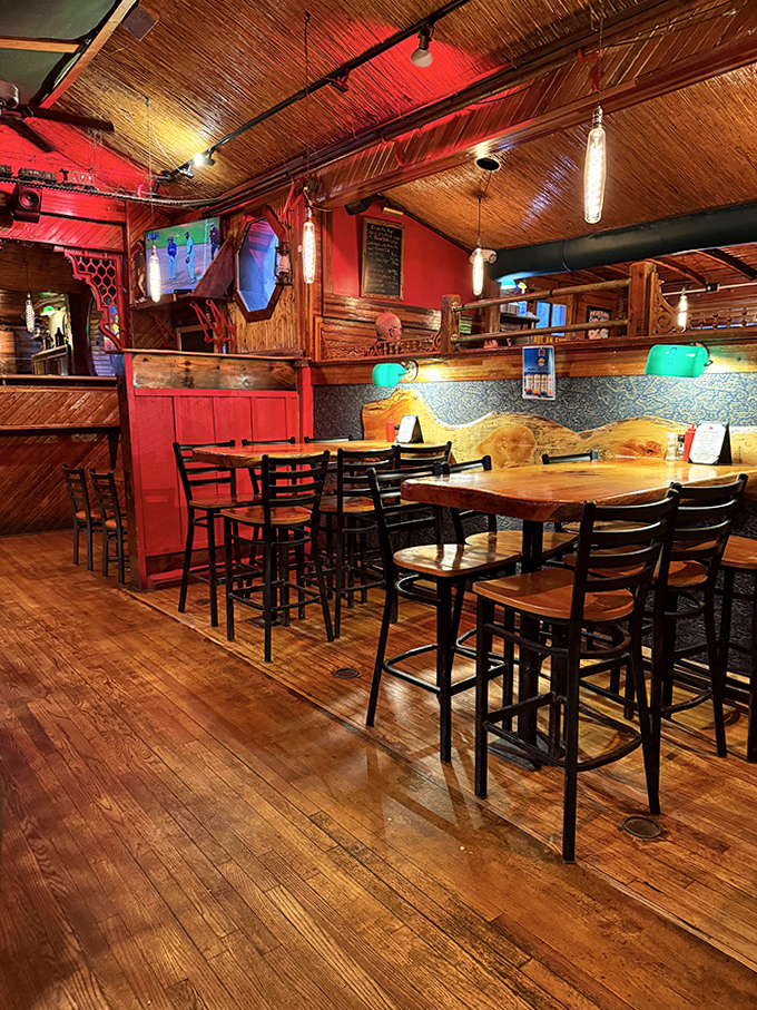 Wooden tables bathed in warm light create intimate dining spaces where conversations flow as easily as the Vermont craft beers on tap.