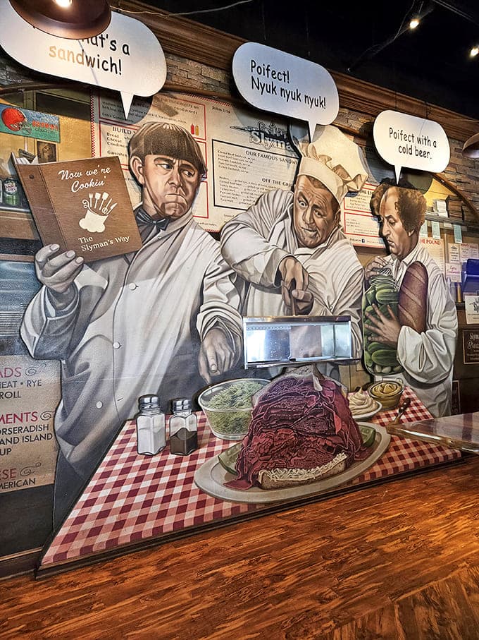 Wall art featuring comedy legends preparing sandwiches with attitude. Even they seem impressed by the size of Slyman's legendary corned beef portions.