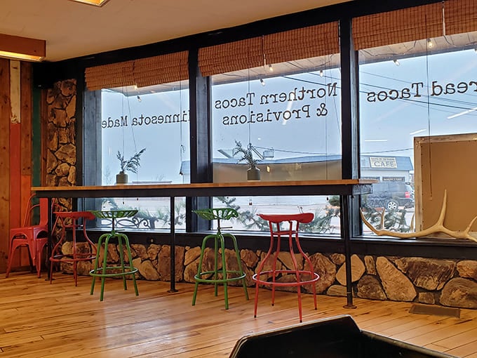 Colorful stools line a counter with a view &ndash; because the only thing better than eating amazing tacos is doing so while gazing at Grand Marais.