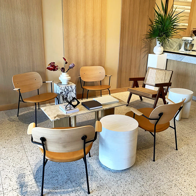 Mid-century modern meets bakery chic in this cozy seating area designed for lingering conversations over coffee and cake.