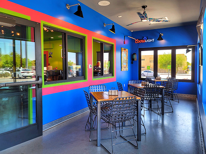 Bold blue walls and lime green accents create a vibrant seating area that's as lively as the flavors coming from the kitchen.