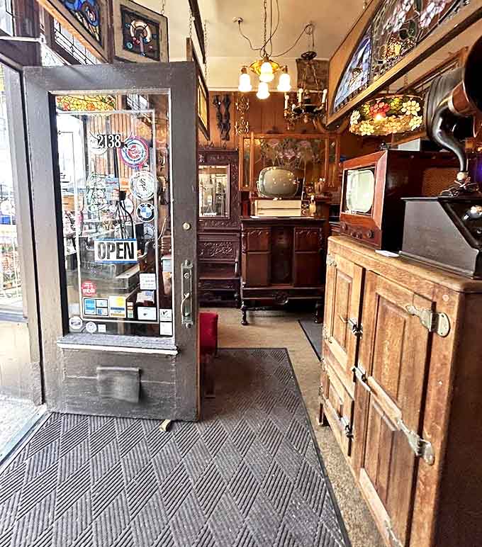 Step through this doorway and leave 2023 behind &ndash; vintage televisions and wooden cabinets mark your entry.