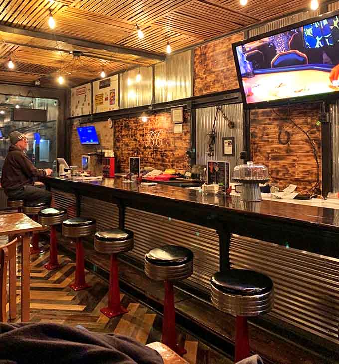 The bar area offers a perfect perch for solo diners or couples wanting to watch the action while enjoying their meal.