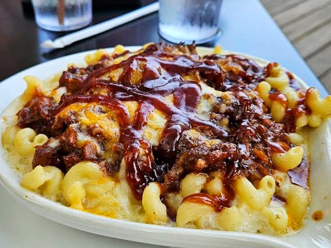 Baked mac and cheese topped with barbecue and drizzled with sauce is what happens when comfort foods join forces for good.