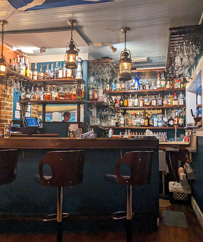 The bar isn't just stocked—it's curated, with nautical lanterns casting a glow that makes every drink look like liquid gold.