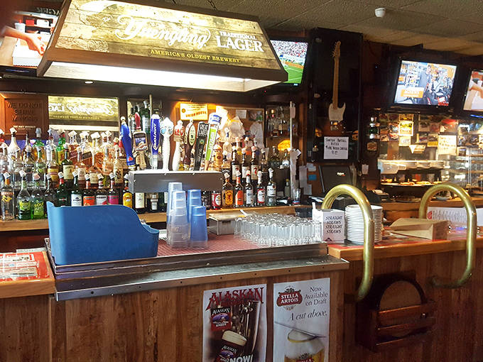 The well-stocked bar stands ready to quench any thirst, with taps flowing and bottles gleaming under lights that promise good times ahead.