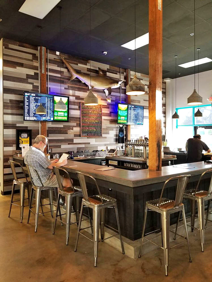The bar's reclaimed wood paneling and digital beer menu blend rustic charm with modern brewery tech.