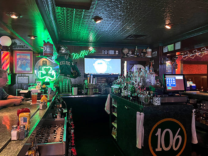 The ceiling's vintage pressed tin catches the green glow from neon signs, creating an atmosphere that's both energetic and somehow soothing.