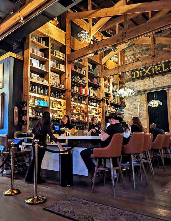 Bartenders move with surgical precision and Vegas showmanship behind a bar that requires library ladders to reach its highest shelves of premium spirits.