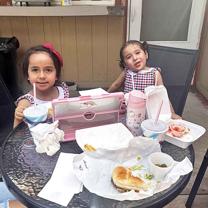 The outdoor patio buzzes with conversation and contentment as diners savor their meals under the Michigan summer sky.