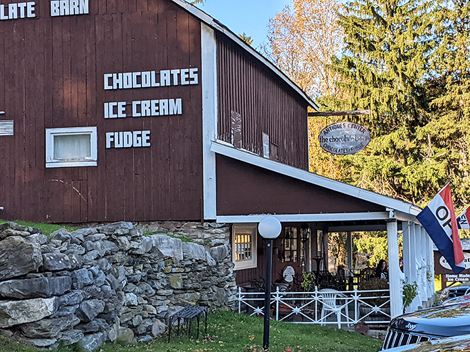 The side view reveals the barn's rustic character with "CHOCOLATES ICE CREAM FUDGE" proudly displayed. This building has seen generations of sweet tooths satisfied.