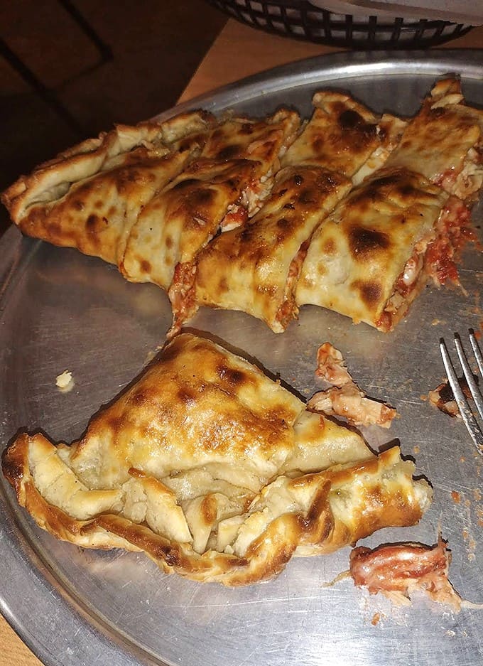 A golden-brown pocket of joy stuffed with cheese and toppings, baked until bubbly and irresistible. Pizza's sophisticated cousin has never looked better!