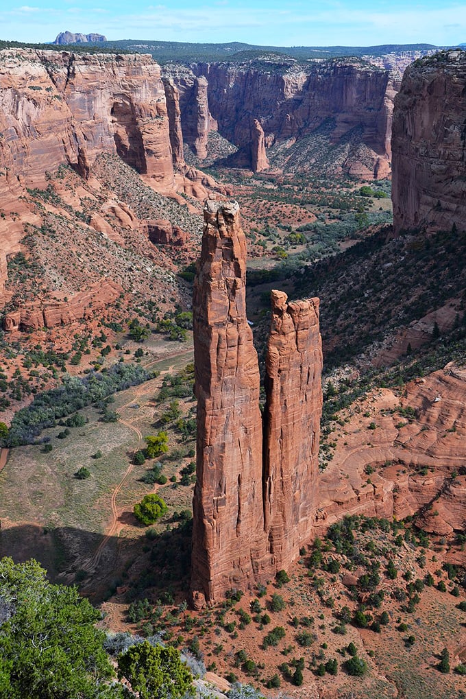 Canyon de Chelly reveals its dramatic depths, where towering rock spires reach skyward like nature's attempt at cathedral architecture.