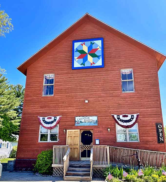 Caseville Historical Society's rustic red building preserves stories of yesterday while welcoming visitors with small-town warmth.