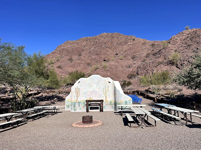 A desert amphitheater provides the perfect gathering spot, where picnic tables await beneath painted desert skies.