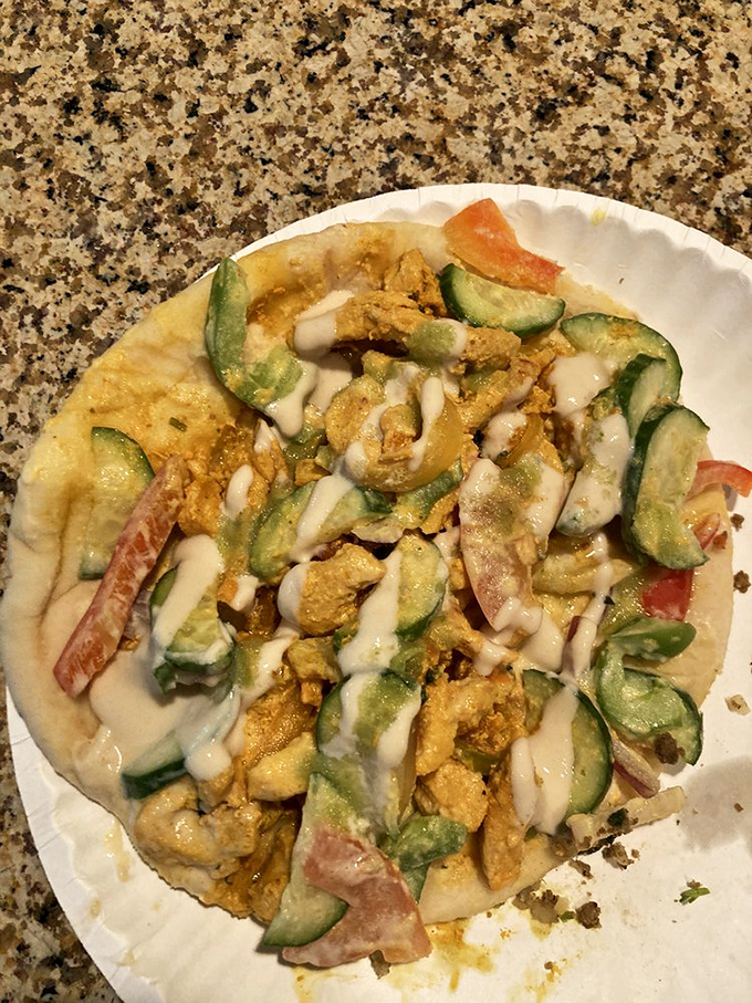 Chicken shawarma perfection, tender spiced meat with fresh vegetables and creamy sauce, all wrapped in warm flatbread. Portable happiness!