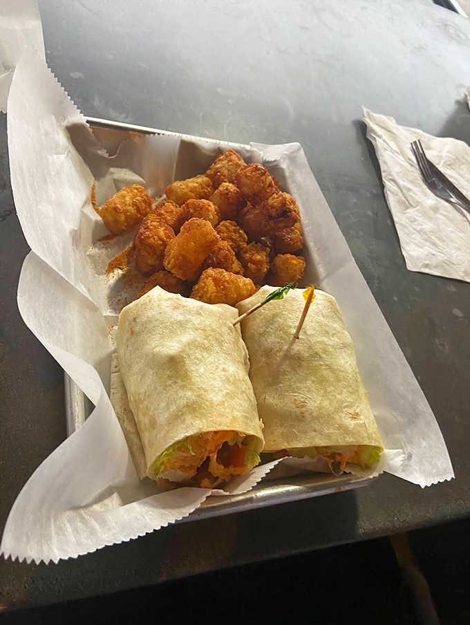 Handheld happiness alongside golden tots! When you need your wing fix in a neater package, this wrapped wonder delivers the goods.