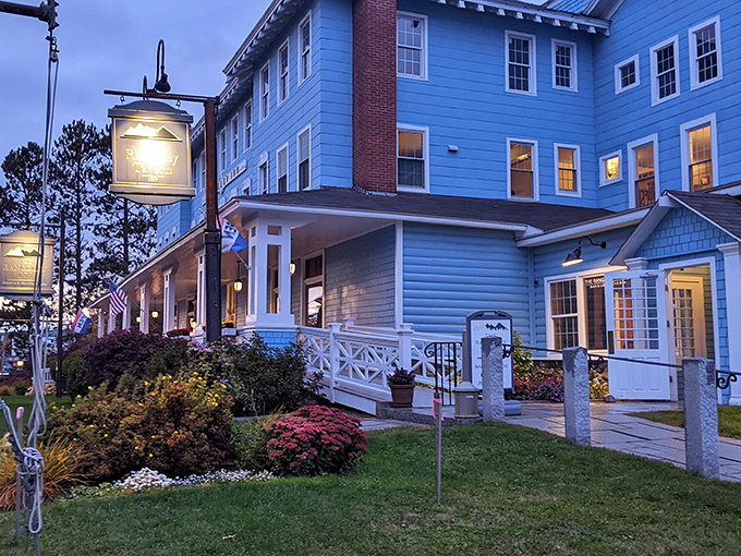 Evening light bathes The Rangeley Inn in a warm glow, inviting weary travelers to step back in time at this historic Maine landmark.