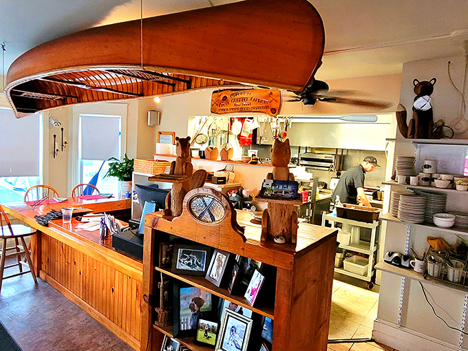 Canoe suspended from the ceiling watches over the open kitchen where culinary magic happens without pretense or fuss.