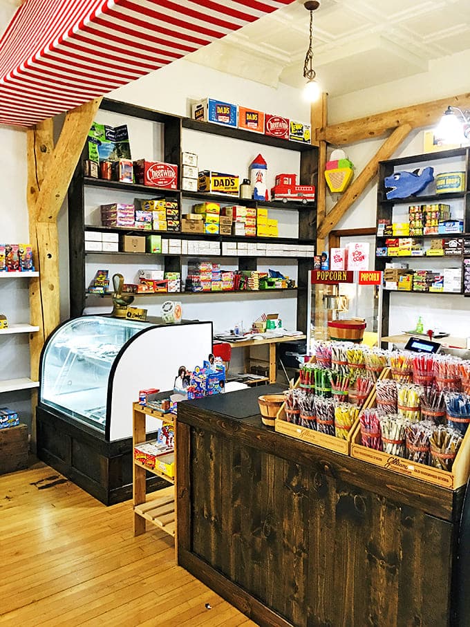 Under the vintage "GARAGE" sign, the counter area combines rustic wood with industrial elements, creating a space that feels both nostalgic and thoroughly modern.