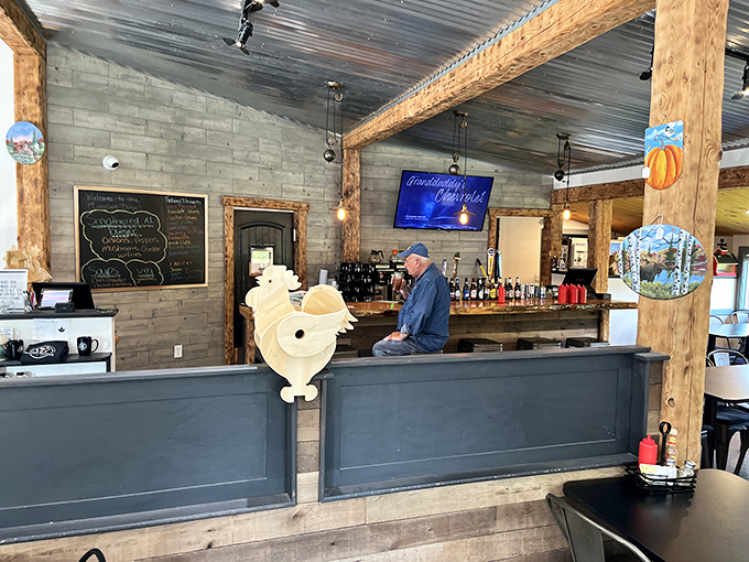 The heart of operations: A rustic wooden bar where coffee flows freely and the wooden rooster mascot keeps watchful eye over proceedings.